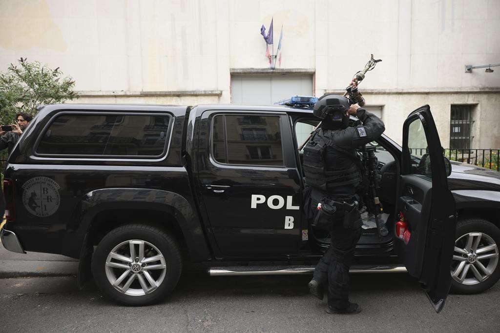 Police in Paris detain a man wearing fake explosives vest at Iran's ...