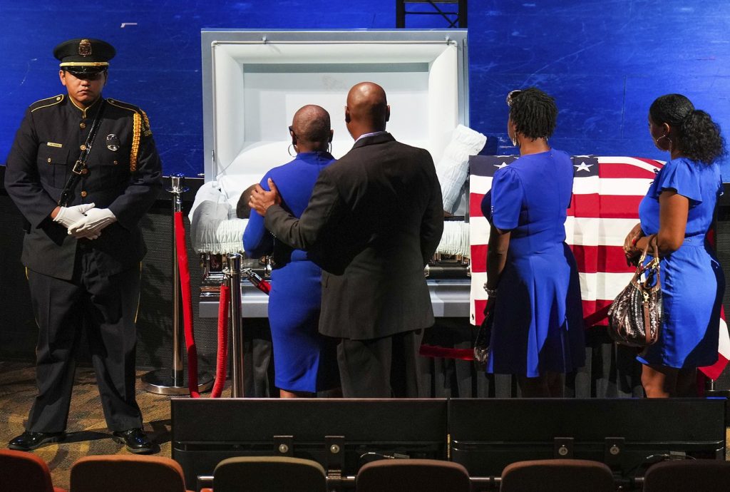 Dallas police officer who was fatally shot remembered as 'hero' during ...